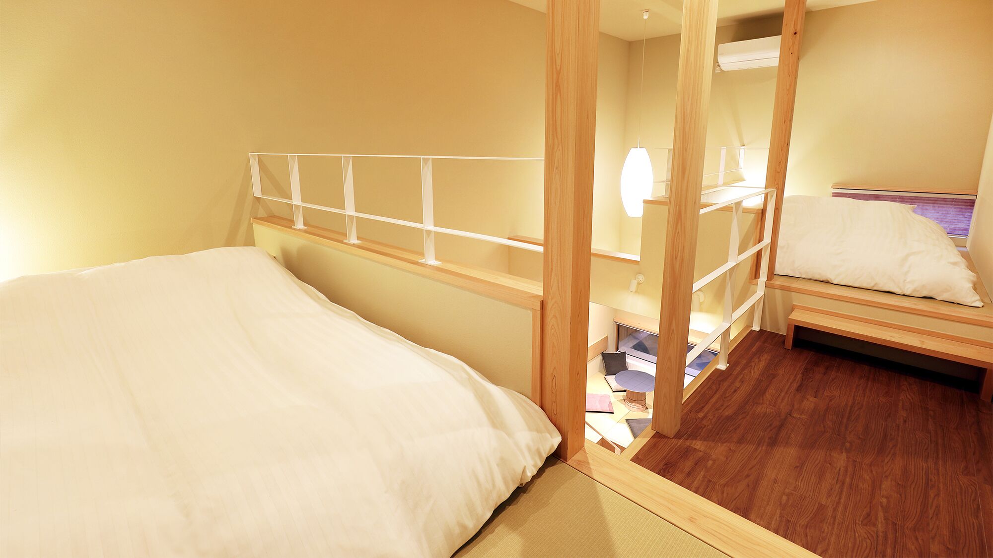 Uma cama de solteiro com cabeceira de madeira, mesa de cabeceira e uma cadeira pequena.