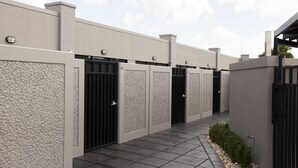 Um edifício moderno com vários portões pretos e paredes com textura.