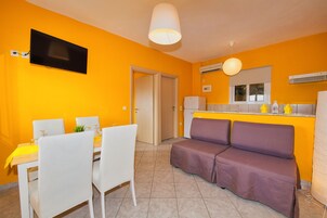 Apartamento, 1 quarto, vista para o mar | Sala de estar | Televisor