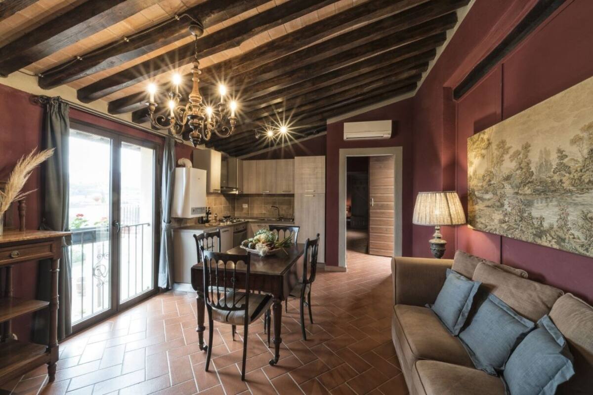 Uma sala de jantar acolhedora com uma mesa de madeira, cadeiras e um lustre.