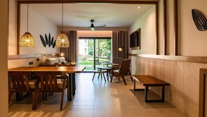 Uma sala de jantar com mobiliário de madeira, luminárias pendentes e vista para o exterior.