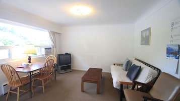 Quarto luxo, 1 quarto | Área de estar | TV