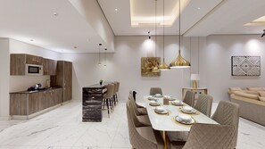 Uma cozinha moderna com eletrodomésticos embutidos, uma sala de jantar com mesa de mármore e uma sala de estar com sofá.