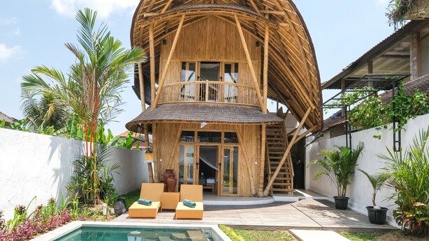 Uma casa de madeira espaçosa, com piscina e área de estar ao ar livre.