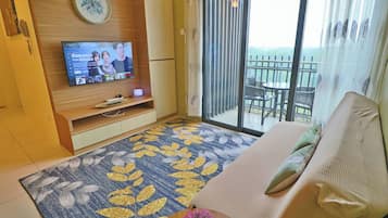 Apartamento Deluxe, 2 quartos, vista para o mar, junto à praia | Sala de estar | Televisor LCD de 55 polegadas com canais digitais, Netflix