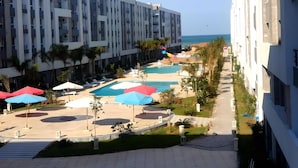 Um hotel moderno com área de piscina, espaço ao ar livre e vista para o mar.