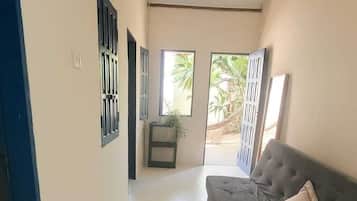 Suíte conforto | Área de estar | TV de tela plana