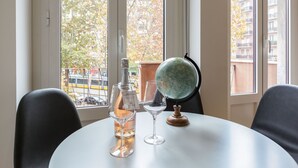 Uma mesa redonda com uma garrafa de vinho, uma taça de vinho e um globo.
