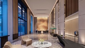 Um lobby moderno com balcão de recepção, área de estar e parede com padrão.