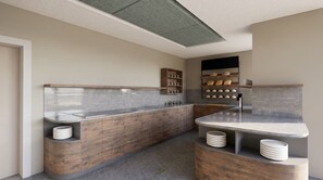 Uma cozinha moderna com ilha curva, armários de madeira e espaço para pão embutido.