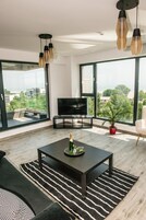 Apartamento panorâmico | Área de estar | Smart TV 80 cm com canais via satélite