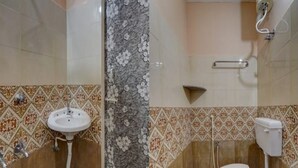 Casa de banho com lavatório, sanita e zona de duche.