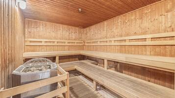 Uma sauna com bancos de madeira e unidade de aquecimento central.