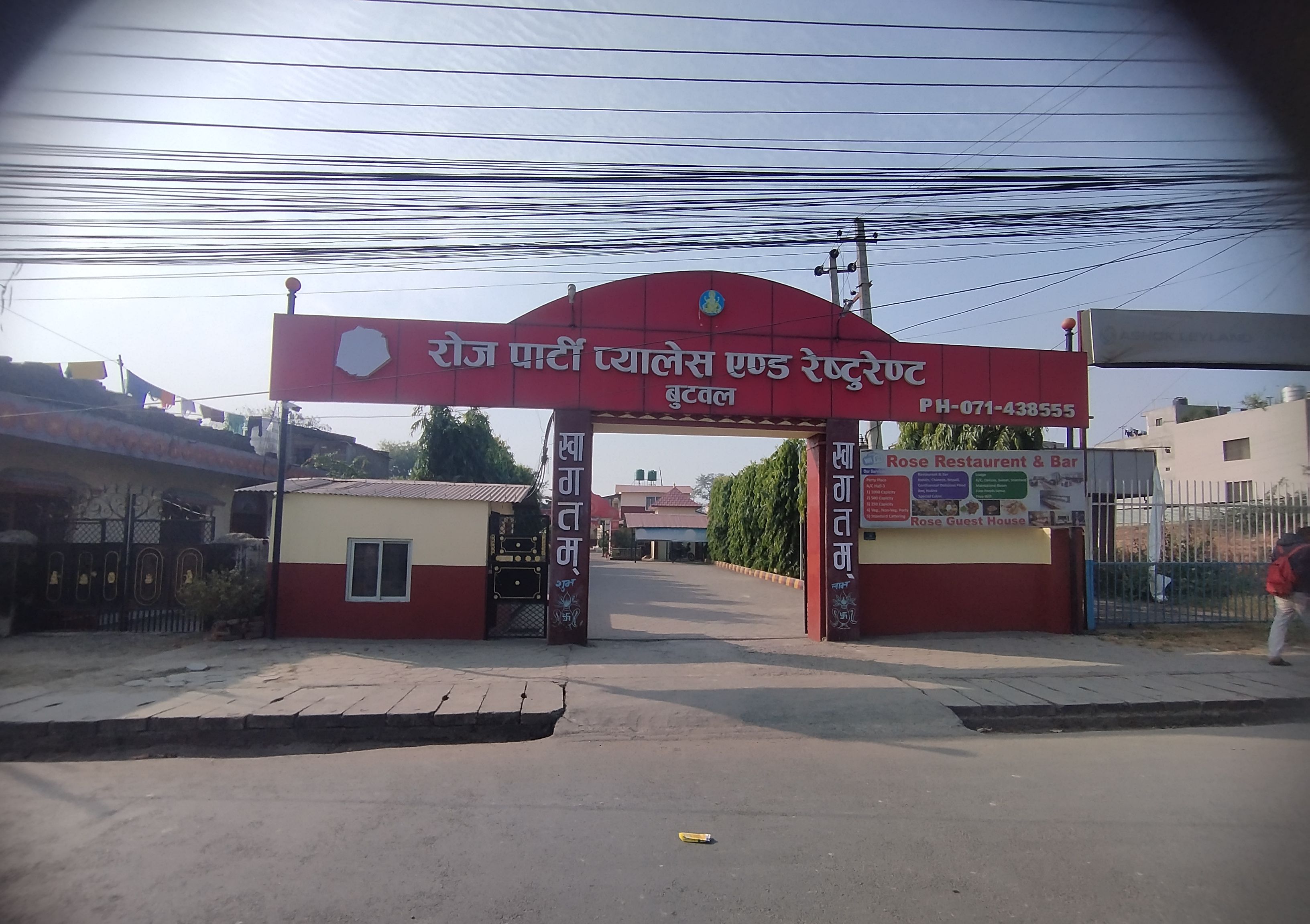 A building entrance with a sign reading "Rose Restaurant & Bar" and a contact number.