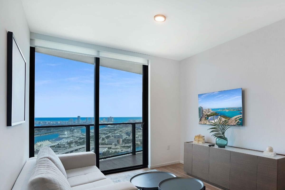 Apartamento Deluxe, 1 cama king-size e sofá-cama, vista para o oceano | Sala de estar | Smart TV de 55 polegadas com canais por cabo