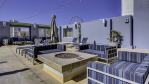Um lounge no terraço com área externa, luzes de Natal e uma lareira.
