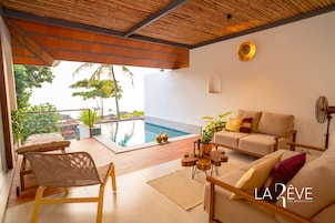 Uma villa moderna com piscina, área de estar ao ar livre e vista para a paisagem circundante.