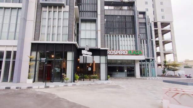 Um edifício moderno com um andar térreo comercial, incluindo o restaurante D'Bone e a Rospero Plaza.