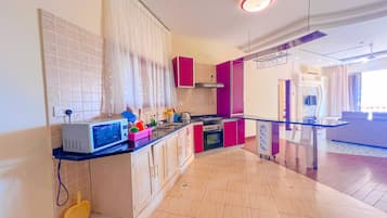 Um frigorífico, um micro-ondas, um forno, uma placa de cozinha