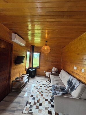 Chalé romântico | Área de estar | Smart TV 32 polegadas com canais digitais, lareira