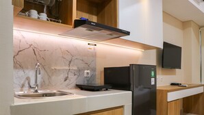 Uma cozinha moderna com fogão embutido, pia e geladeira.