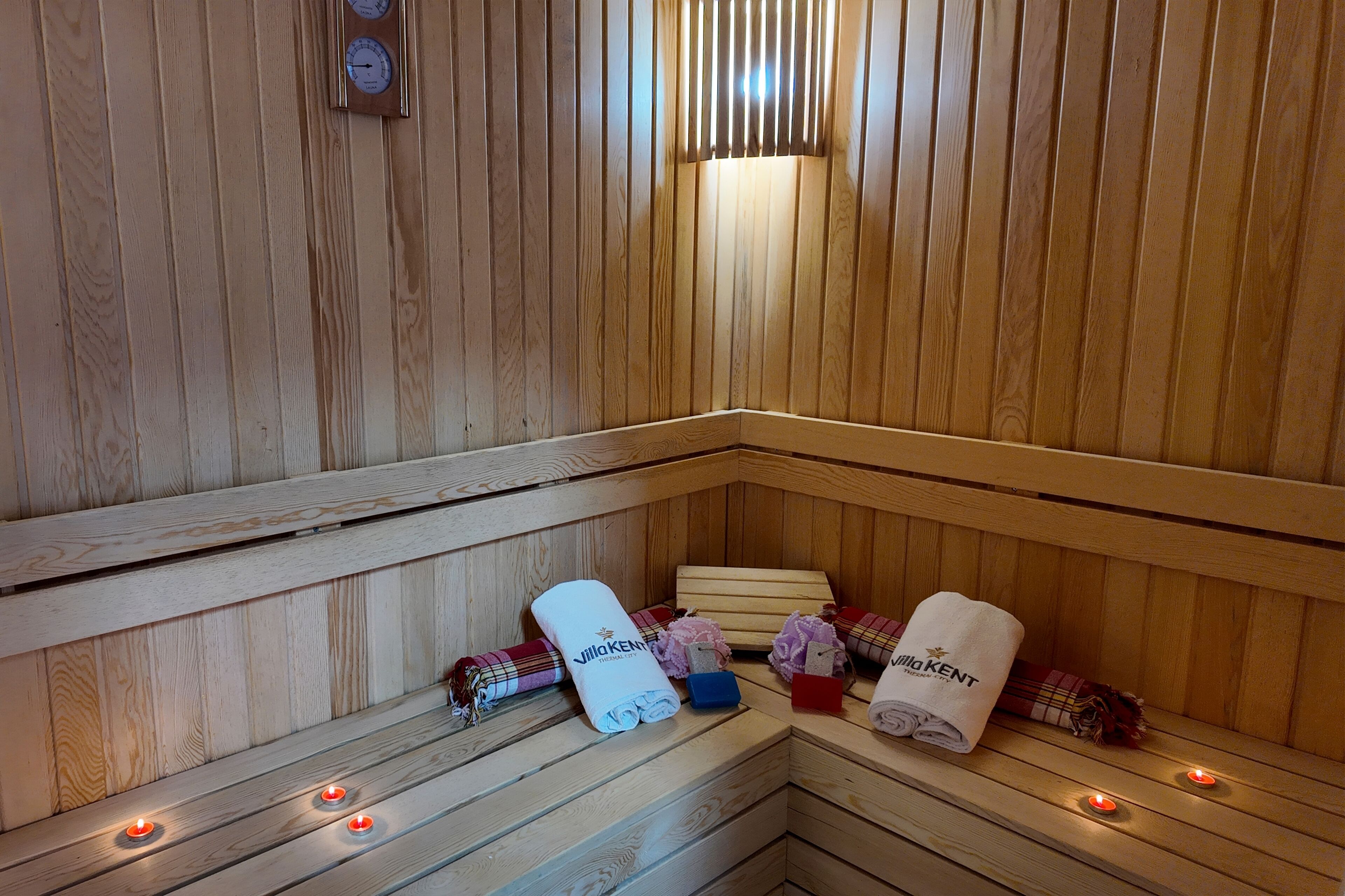 Uma sauna de madeira com bancos e toalhas.