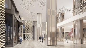 Um hall amplo e moderno, com teto alto, padrões geométricos nas paredes e um corredor central.