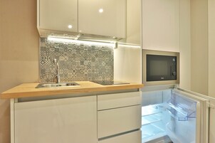 Minifrigorífico, um micro-ondas, uma placa de cozinha, grelhador 