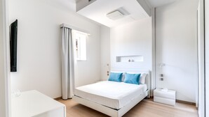 Quarto moderno com cama, mesas de cabeceira e janela com cortinas.