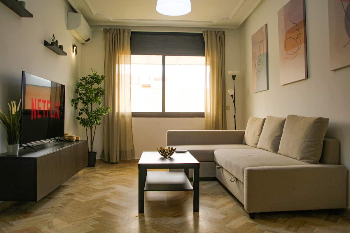 Apartamento básico, vista para a cidade | Área de estar | Smart TV 55 polegadas com canais via satélite, filmes pagos