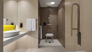 Uma casa de banho moderna com uma grande pia, um chuveiro com chuveiro manual e um porta-toalhas.