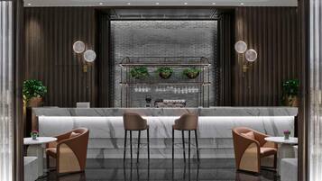 Uma área de bar moderna com bancada de mármore, dois bancos altos e parede de tijolos ao fundo.