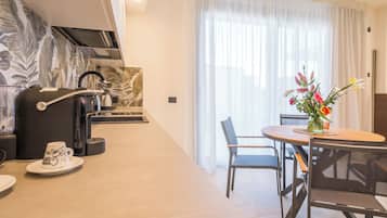 Apartamento Deluxe | Cozinha privada | Um frigorífico, uma placa de cozinha, uma máquina de café expresso