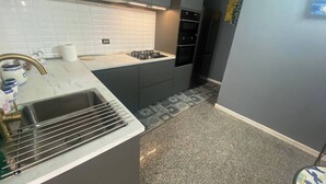 Uma cozinha compacta com pia, fogão e forno.