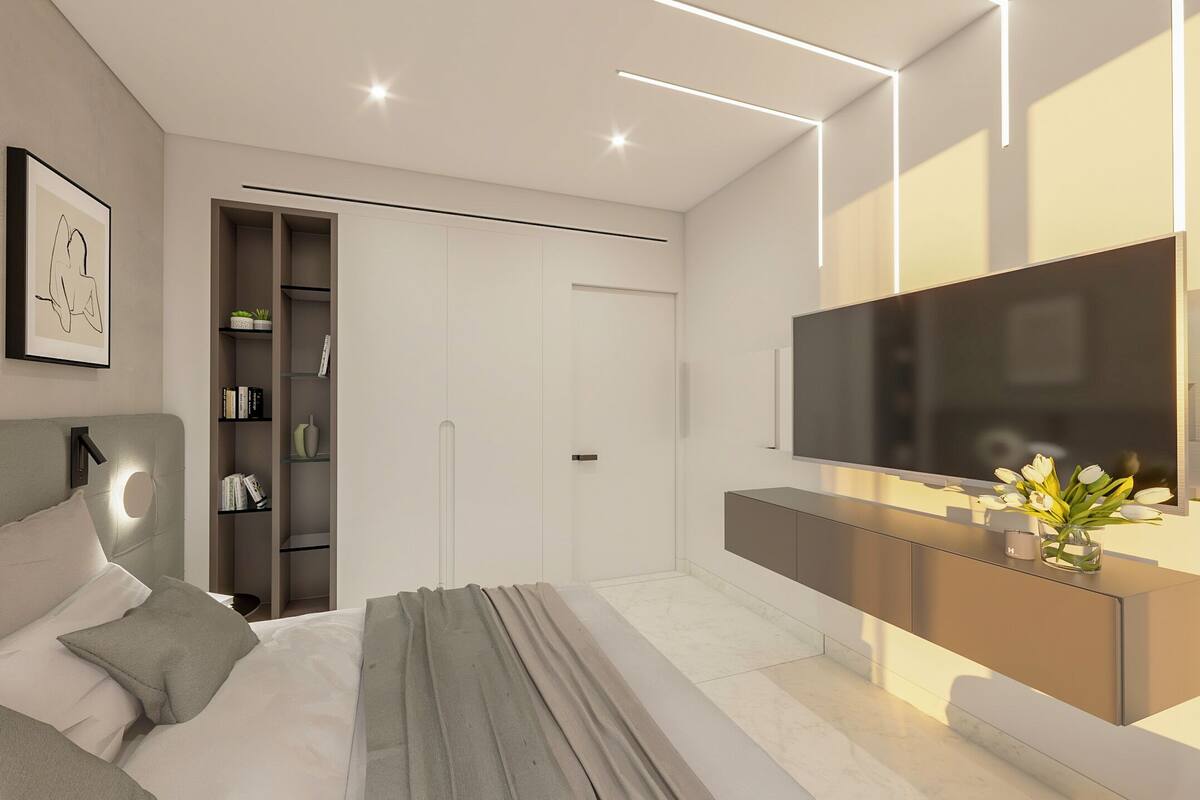 Quarto moderno com cama, mesa de cabeceira, televisão e armário embutido.