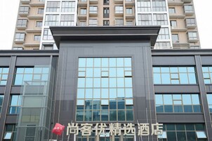 Um hotel moderno com entrada destacada e grandes janelas.