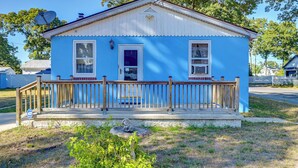 A small, single-story house with a porch and a mailbox.