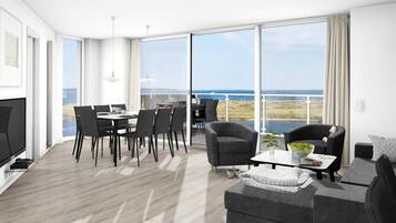 Sala de estar moderna com área de jantar, janelas amplas e vista para o mar.