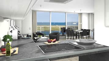 Cozinha moderna com ilha, área de jantar e vista para o mar.