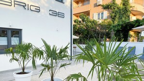 A building with the sign "BRIG 36" and potted plants in the foreground.