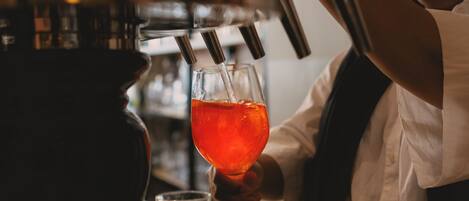 Um bartender a servir uma bebida num copo.