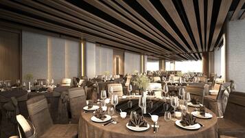 Um salão de banquetes espaçoso, ricamente decorado, com pé-direito alto e mobiliário moderno.