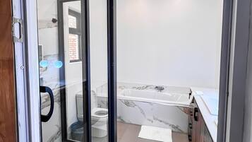 Suite-Estúdio Superior, vista para o jardim | Casa de banho | Um polibã e uma banheira separados, um chuveiro fixo