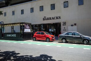 A building with a sign reading "The Barracks" and a "50 Bree Light House" sign.