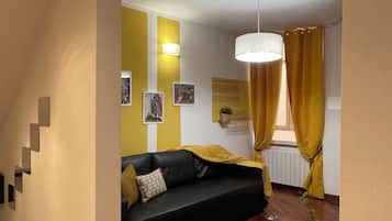 Apartamento família | Área de estar | TV de tela plana, brinquedos