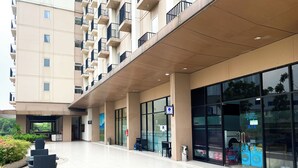 Um edifício moderno com galeria coberta, lavanderia e área de estar ao ar livre.
