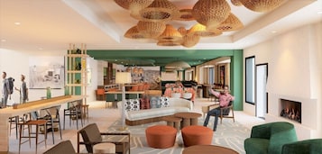 Um hall amplo com sofá, cadeiras, espaço de bar e lareira.