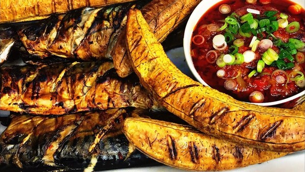 Peixe grelhado e bananas com molho.