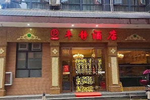 Edifício tradicional com uma placa vermelha indicando um restaurante.