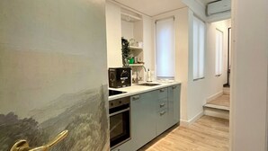 Uma cozinha moderna com forno embutido, pia e bancada.